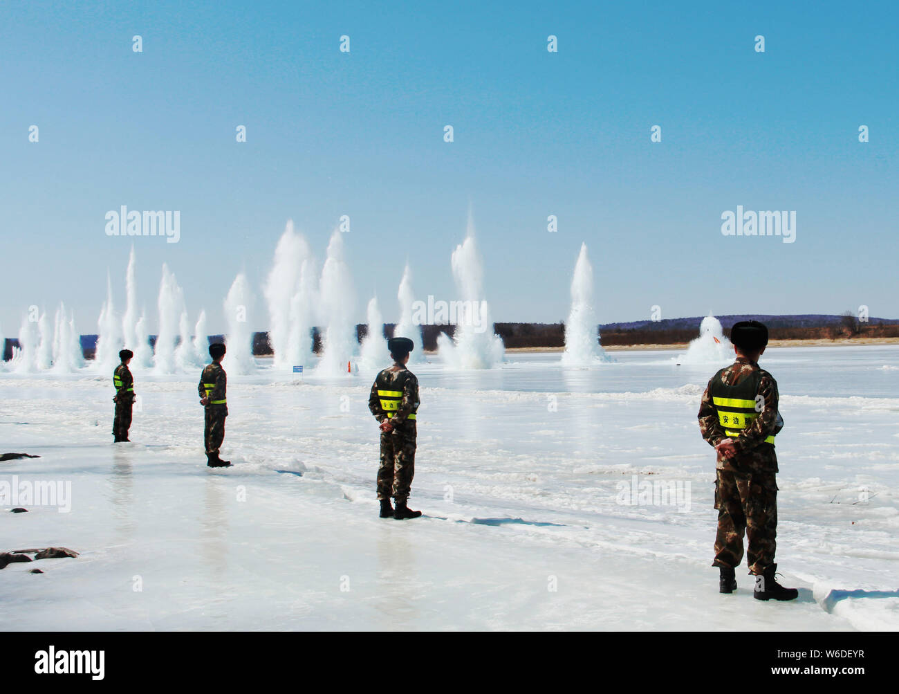 Chinese paramilitary policemen stand guard during an ice blasting in ...