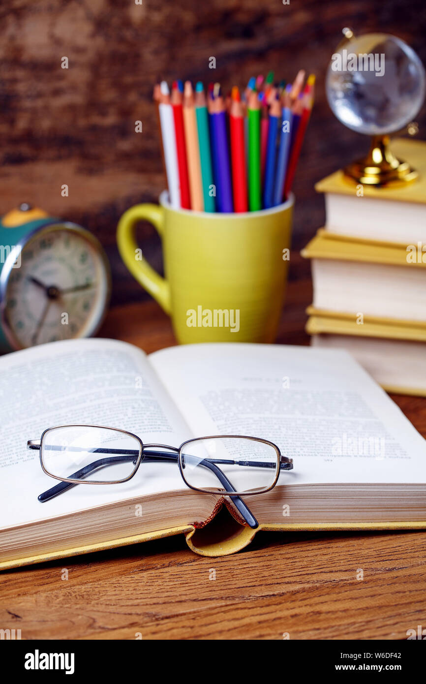 An open book with eyeglasses in the library Stock Photo - Alamy