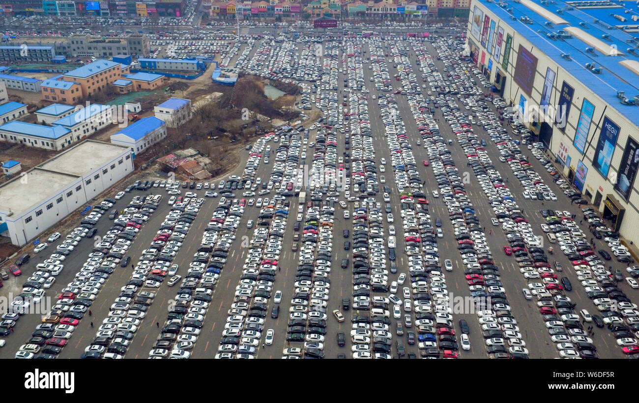 Aerial view of masses of vehicles at a parking lot of a shopping mall ...