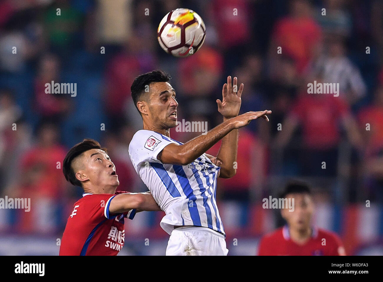 Israeli football player Eran Zahavi, right, of Guangzhou R&F challenges ...