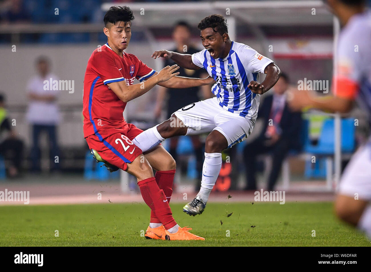 Brazilian football player Renatinho, right, of Guangzhou R&F challenges ...