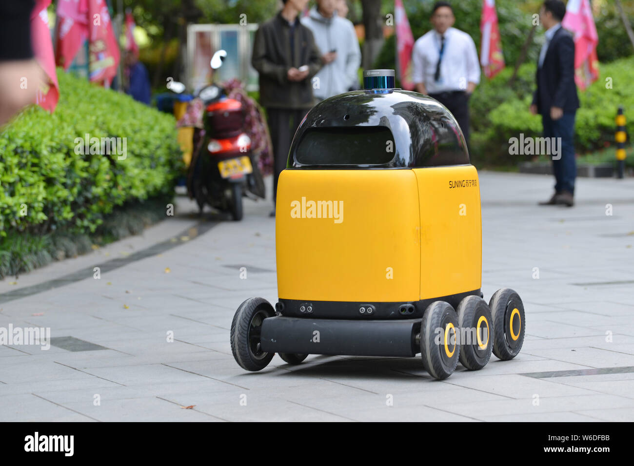 An unmanned delivery car of Suning Logistics is on its way to deliver ...