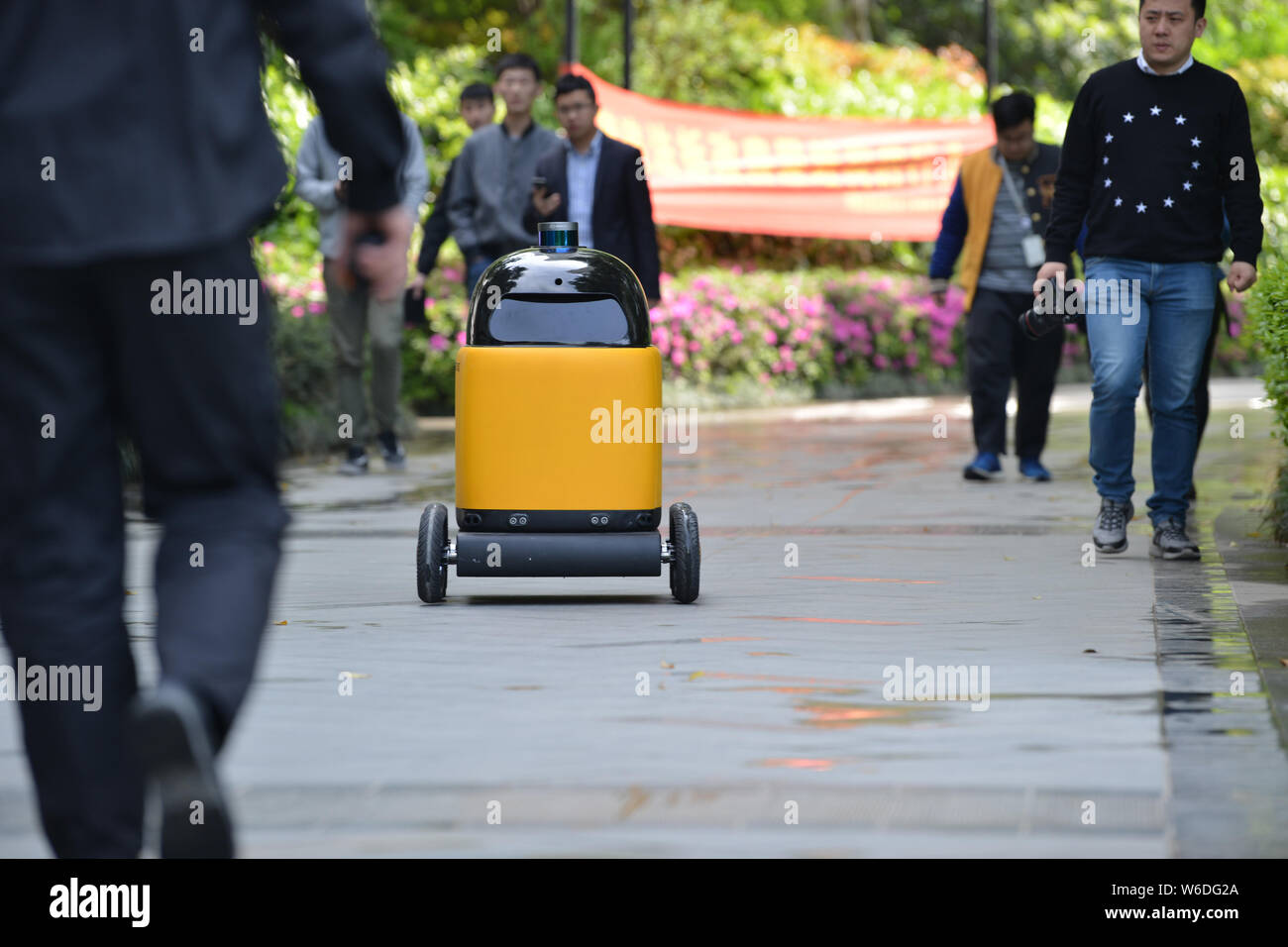An unmanned delivery car of Suning Logistics is on its way to deliver ...