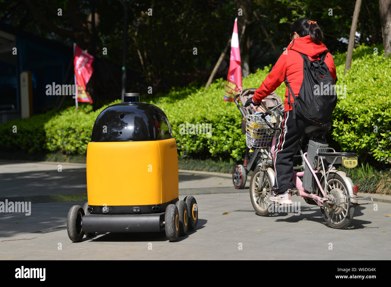 An unmanned delivery car of Suning Logistics is on its way to deliver ...