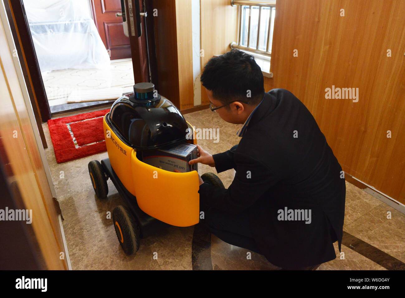 An unmanned delivery car of Suning Logistics is delivering goods at a ...