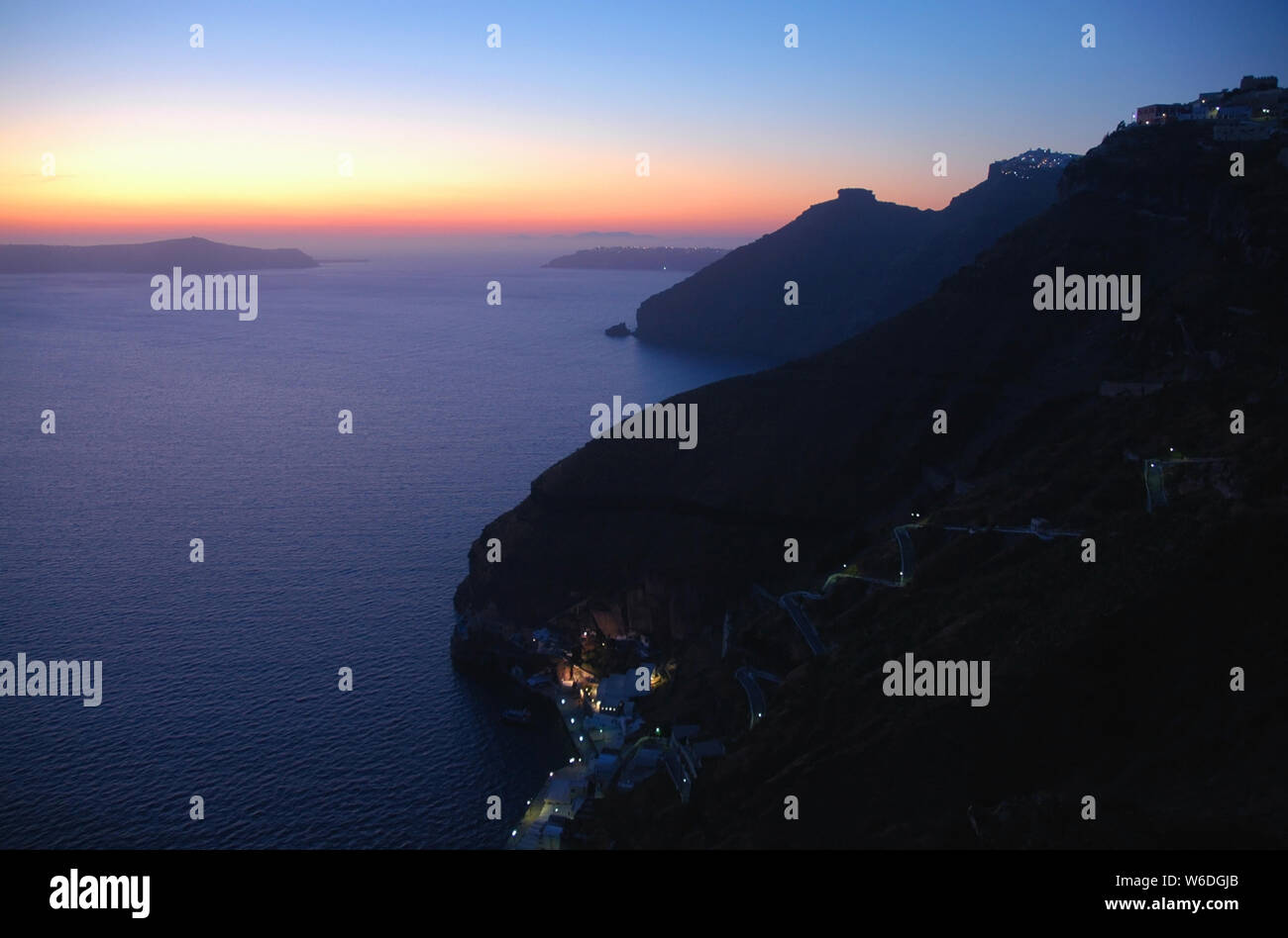 Beautiful sunset from Fira, Santorini Greece. View down to Santorini ...