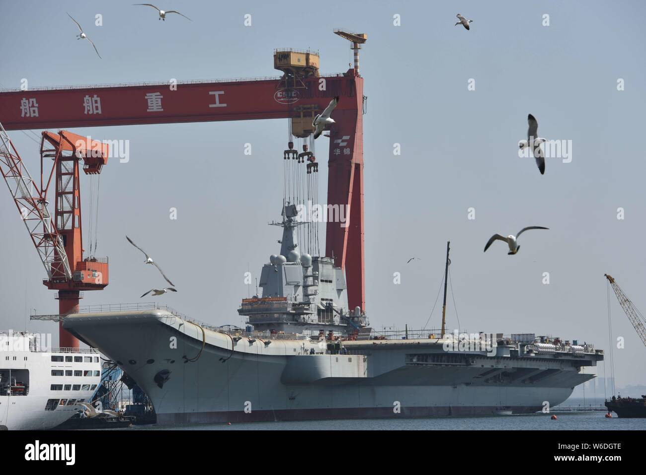 Chinese workers labor on the deck of China's first domestically built ...