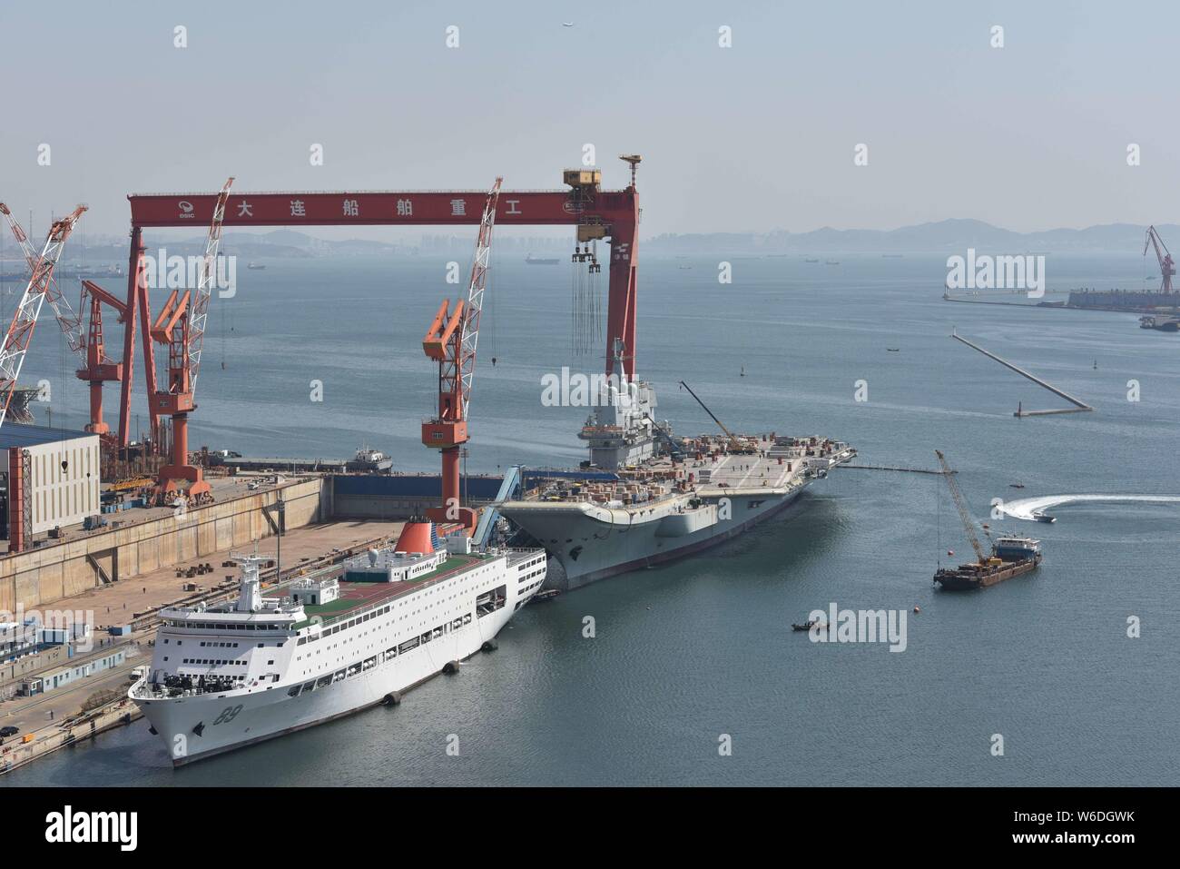 Chinese workers labor on the deck of China's first domestically built ...