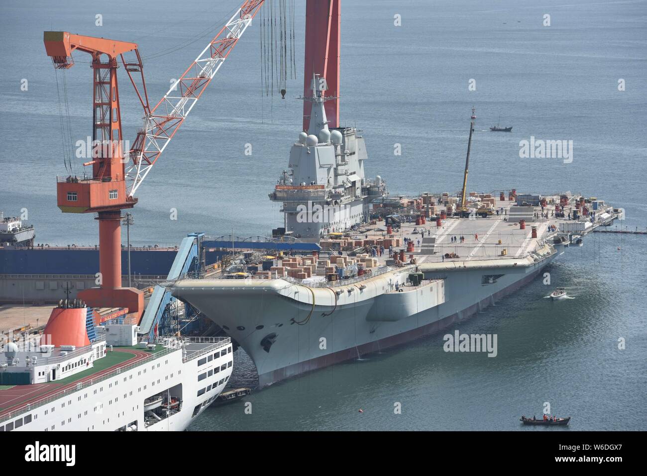 Chinese workers labor on the deck of China's first domestically built ...