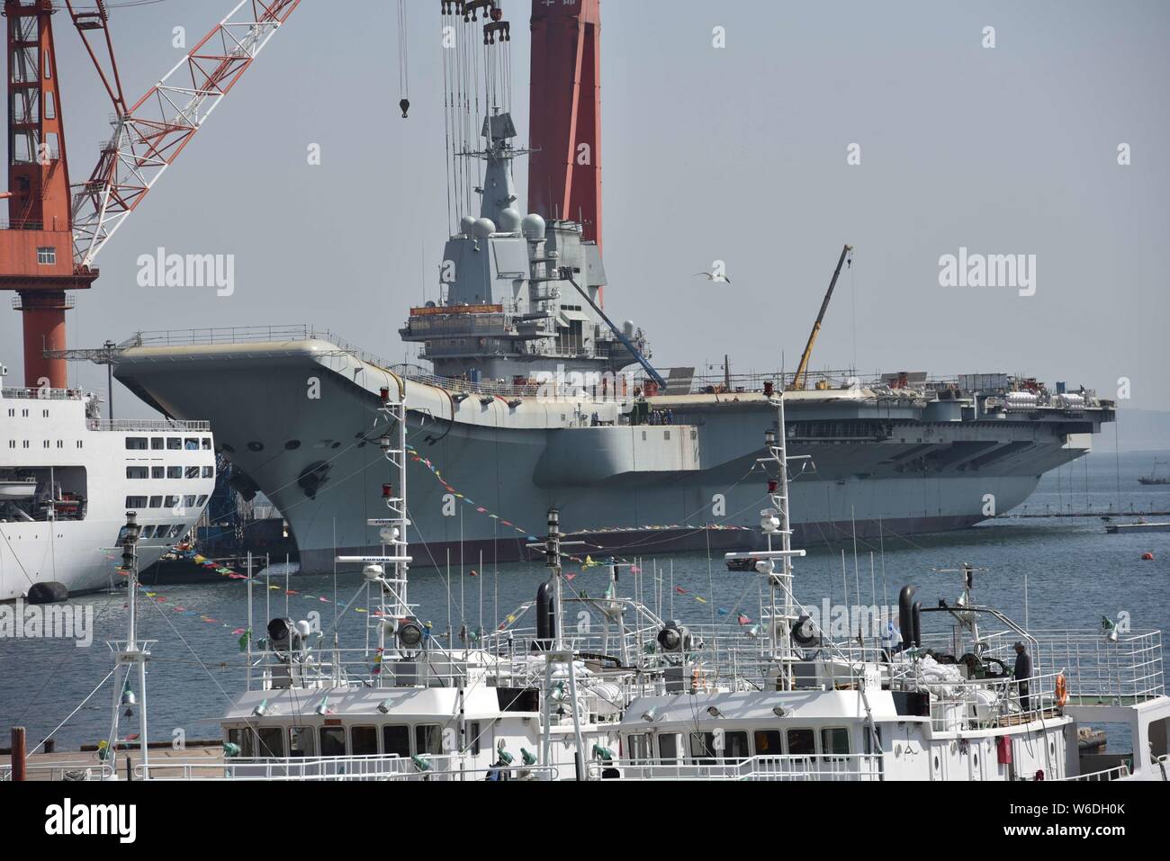 Chinese workers labor on the deck of China's first domestically built ...