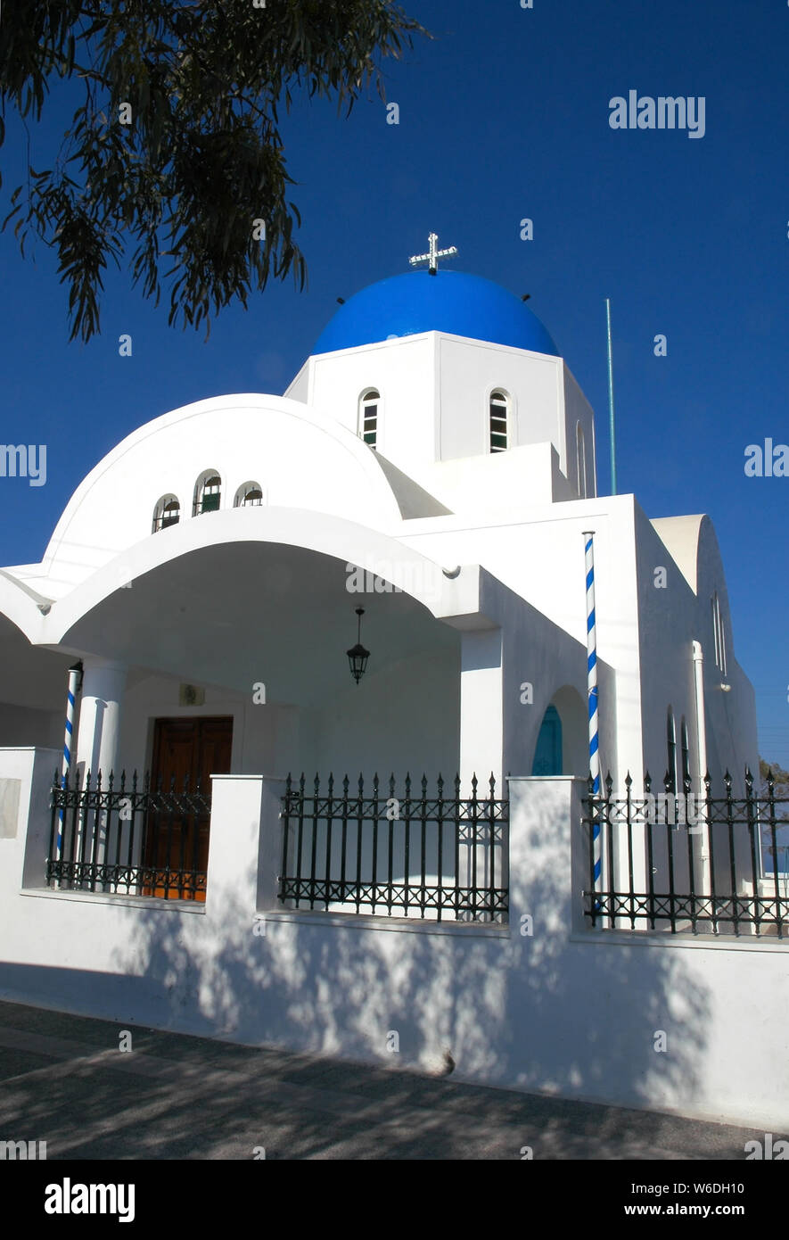 A blue domed church in Santorini, Greece. Santorini is famous for its ...