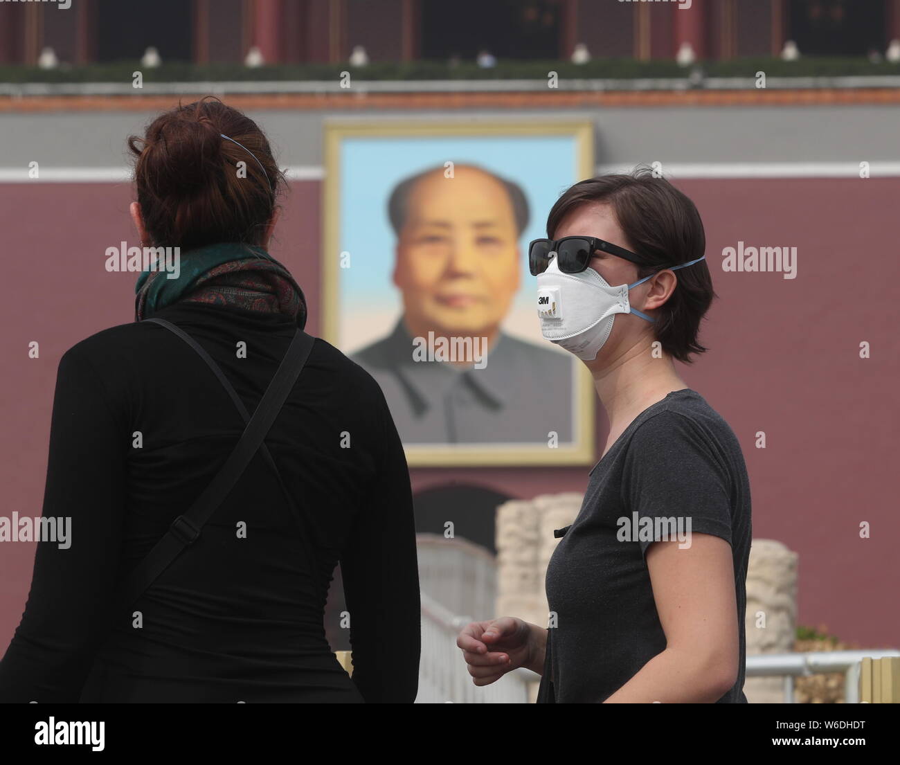 Foreign tourists wearing face masks against air pollution visit the ...