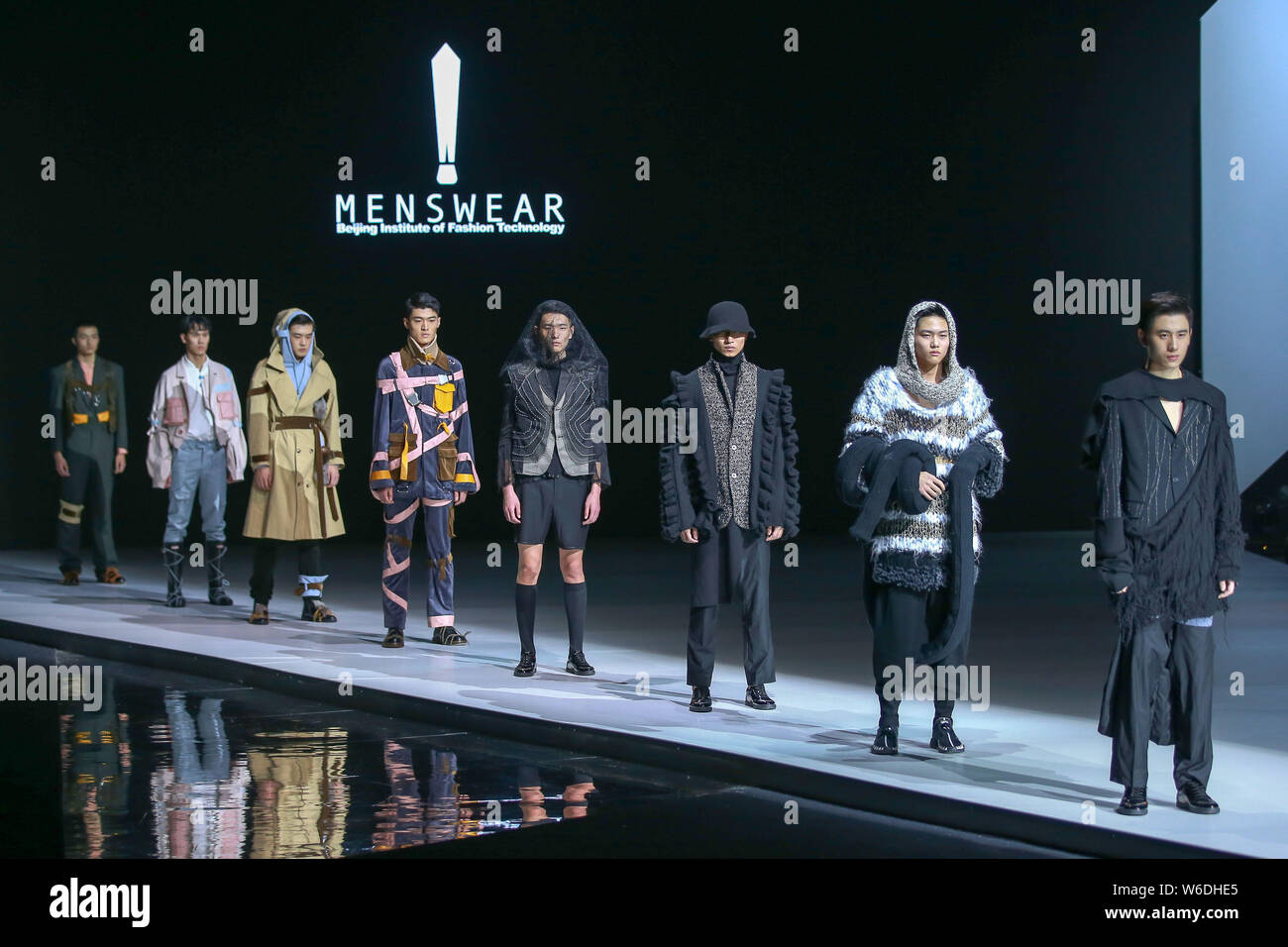 Models display creations of MENSWEAR by graduates during a fashion show ...