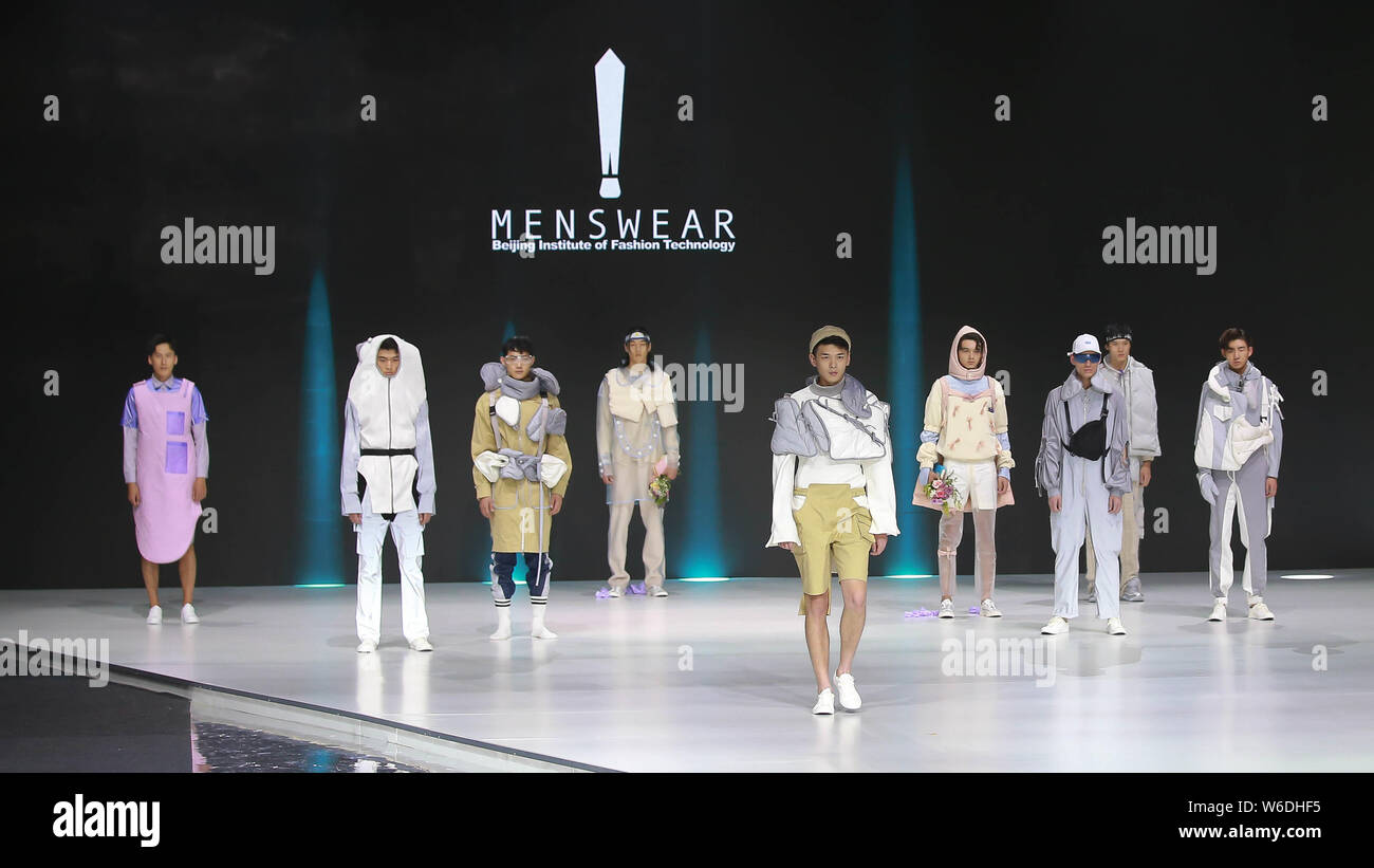 Models display creations of MENSWEAR by graduates during a fashion show ...