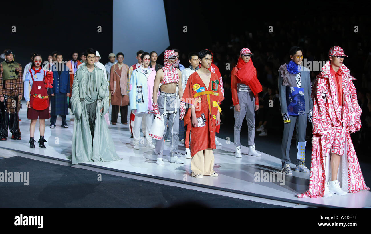 Models display creations of MENSWEAR by graduates during a fashion show ...