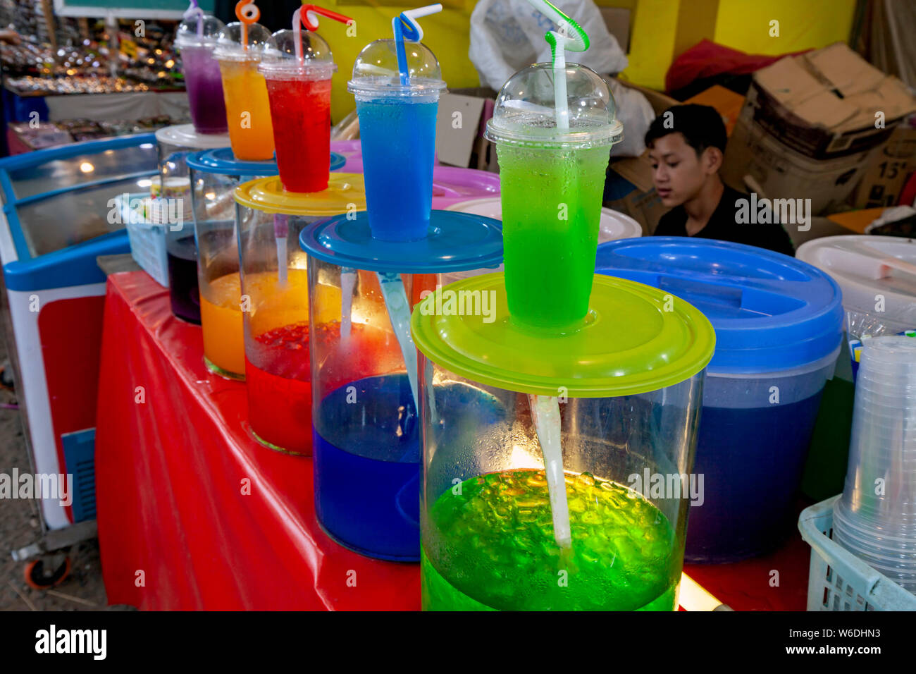 Colorful sweet drinks are for sale at a refreshment stand in Kampong ...