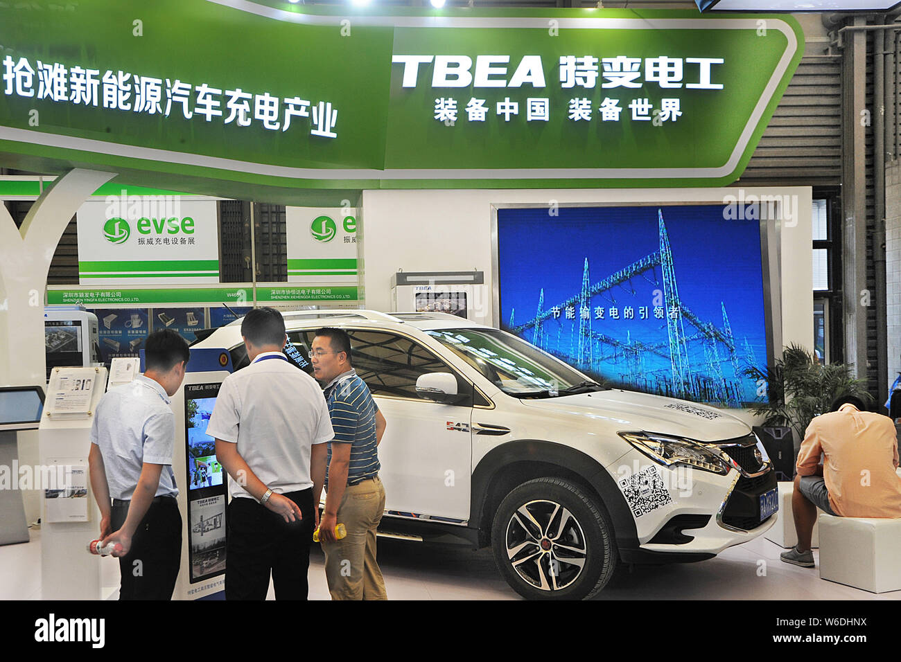 --FILE--People visit the stand of TBEA Sunoasis during an exhibition in ...