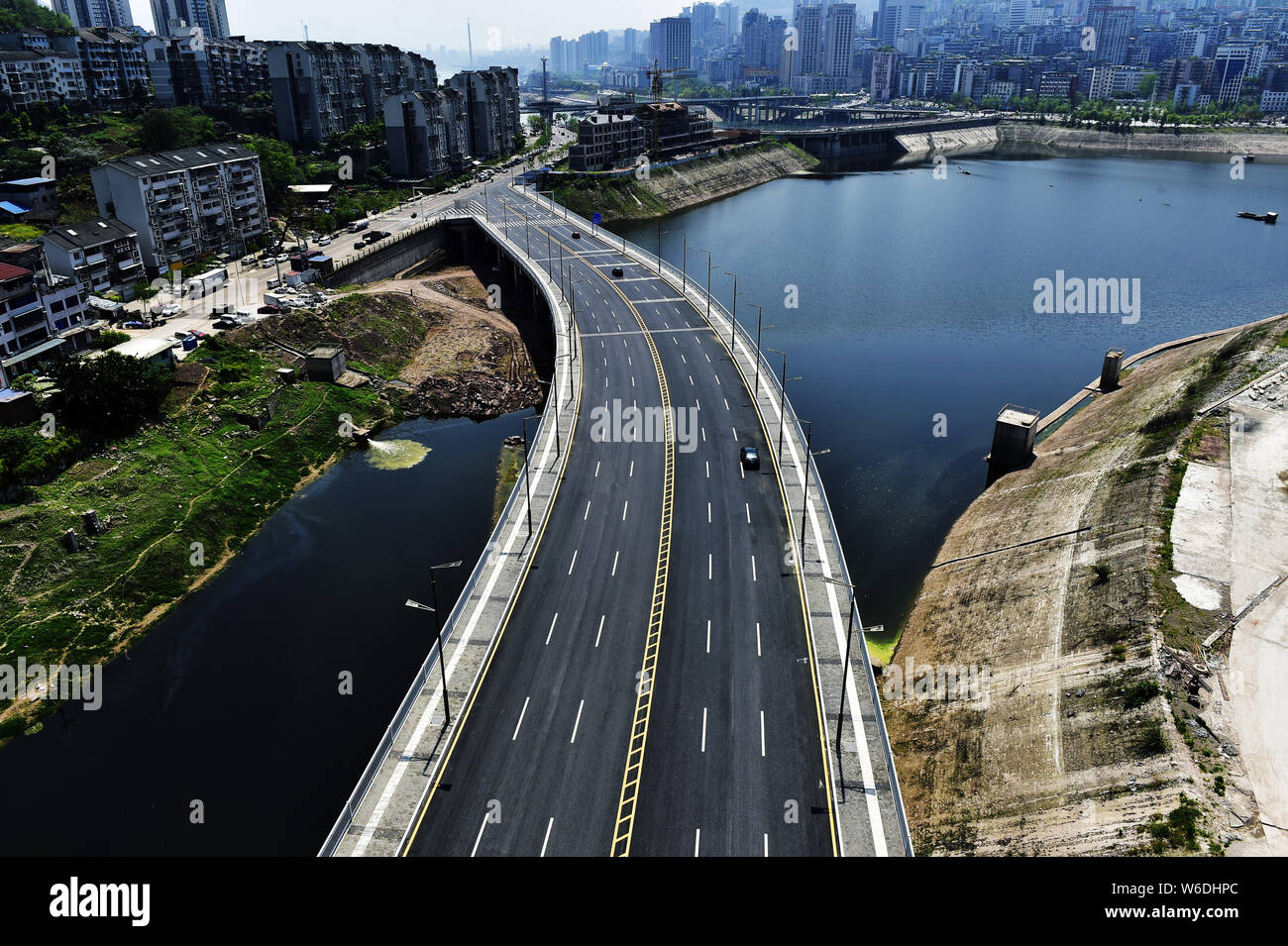 Cars drive on a 5.6-kilometer "overwater highway", linking downtown ...