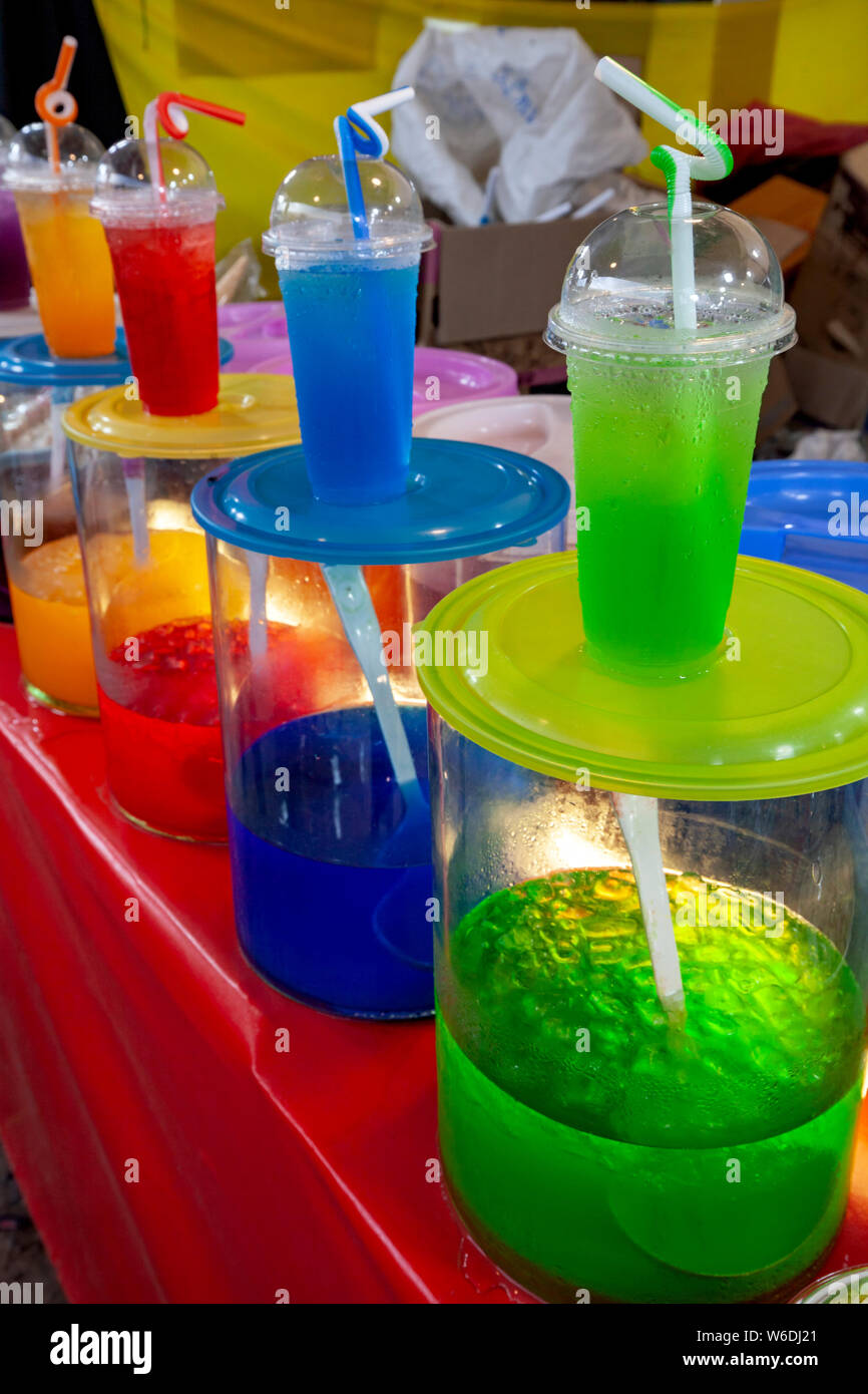 Colorful sweet drinks are for sale at a refreshment stand in Kampong ...