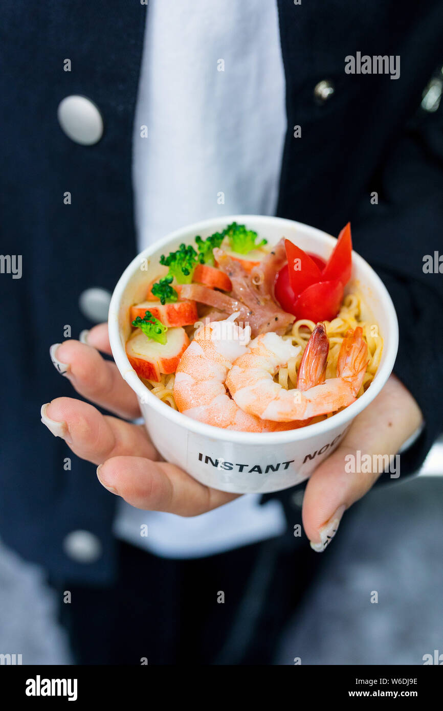 A special instant noodles dish is served at an instant noodles store in ...