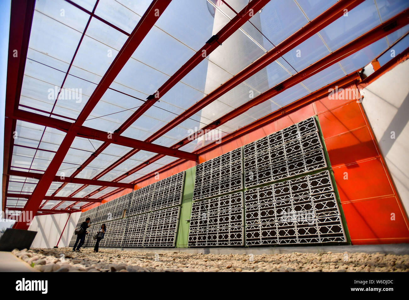 People visit the interior of a 60-meter-tall air purification tower ...