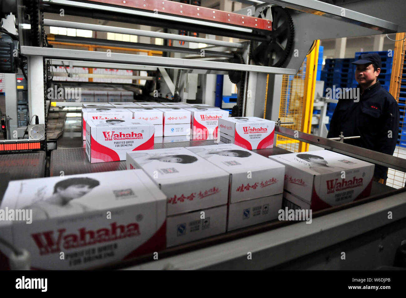 --FILE--A Chinese worker checks boxes of Wahaha purified water on the ...