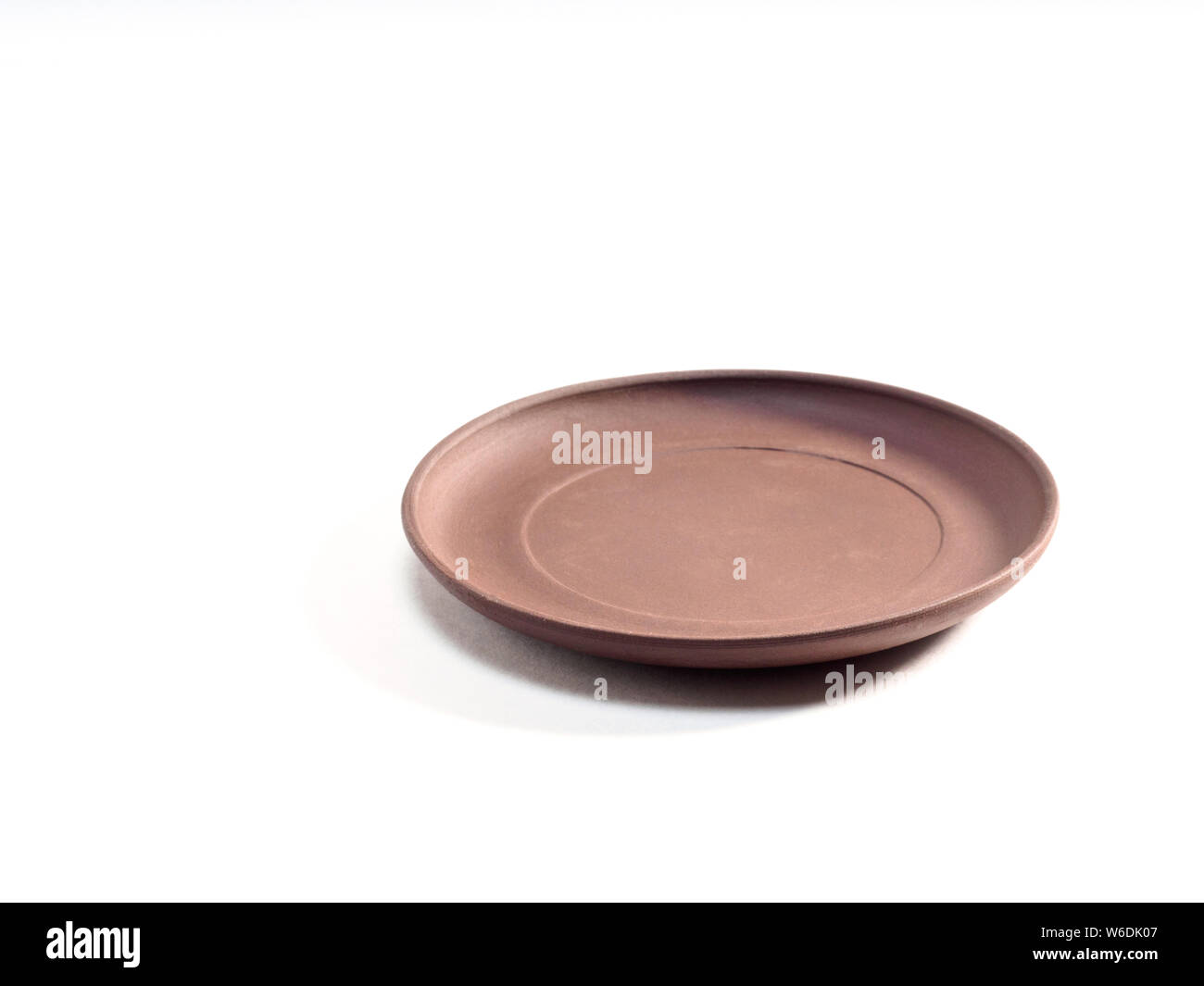 Clay plate on a white background Stock Photo - Alamy