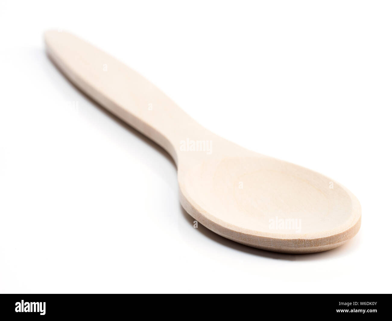 Wooden spoon on a white background diagonally Stock Photo - Alamy