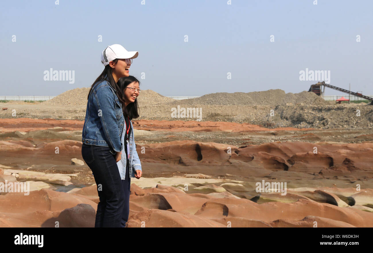 Visitors view the excavation site of the sunken boats owned by peasant ...