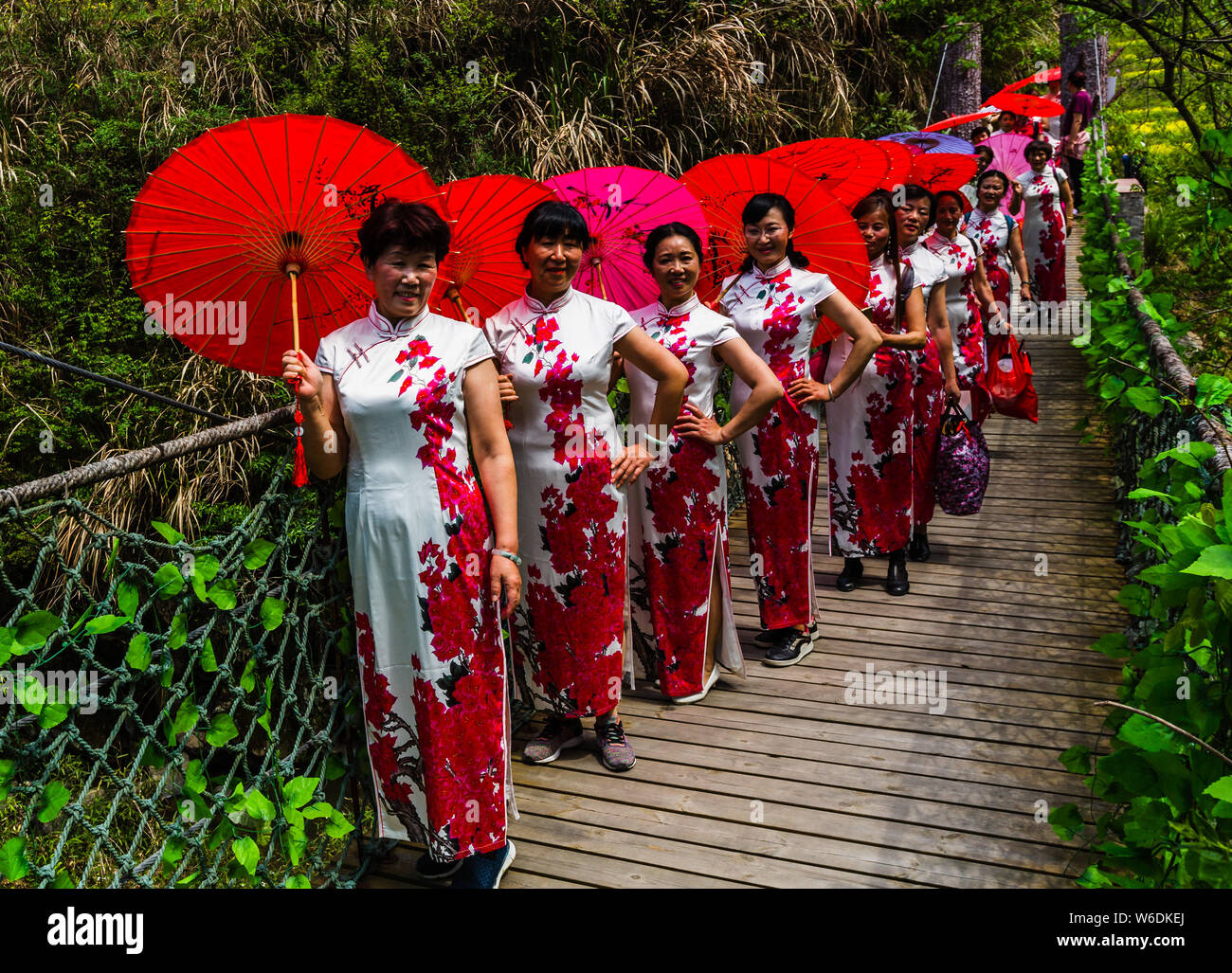Chinese women present cheongsam, also known as qipao in Chinese, during ...