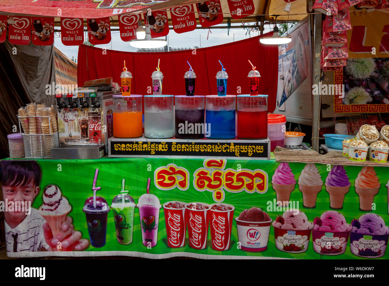 Colorful sweet drinks are for sale at a refreshment stand in Kampong ...