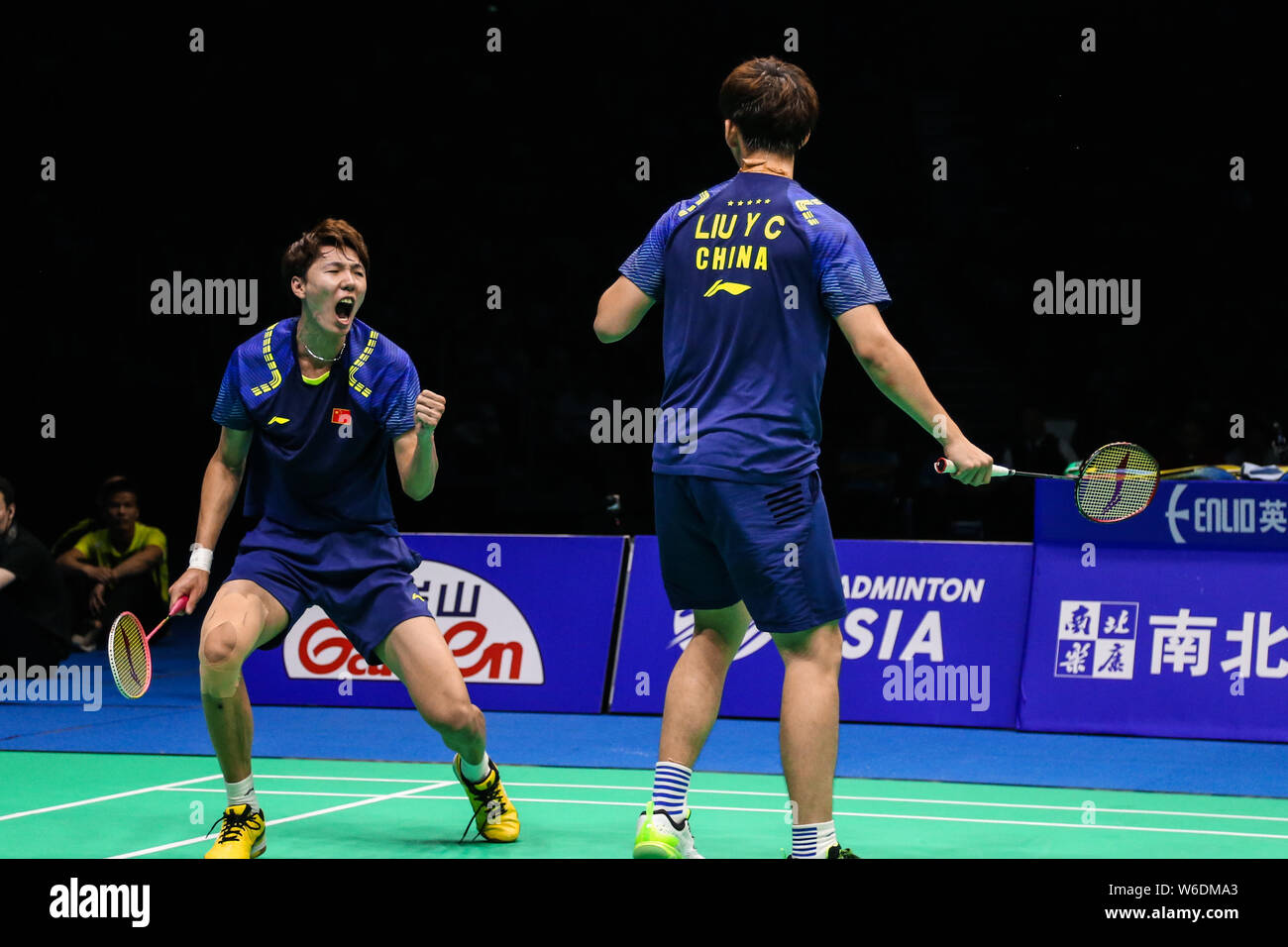 Li Junhui, left, and Liu Yuchen of China interact after scoring against ...