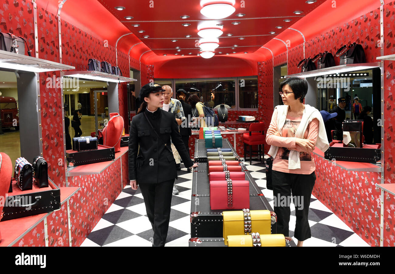Customers visit the pop-up rail themed Prada boutique, "Prada Silver ...