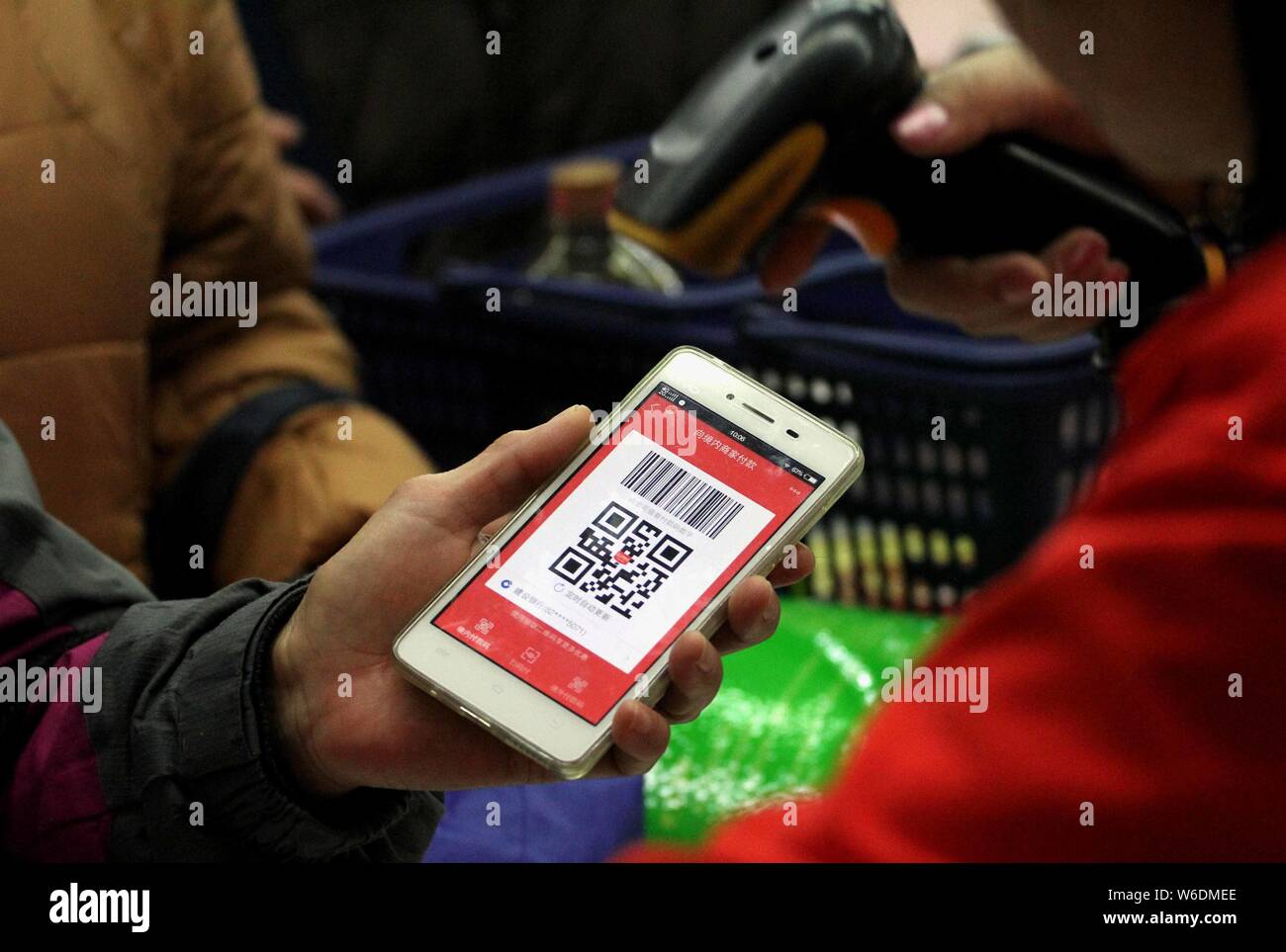 --FILE--A customer has a QR code via the mobile app of Alibaba's online ...