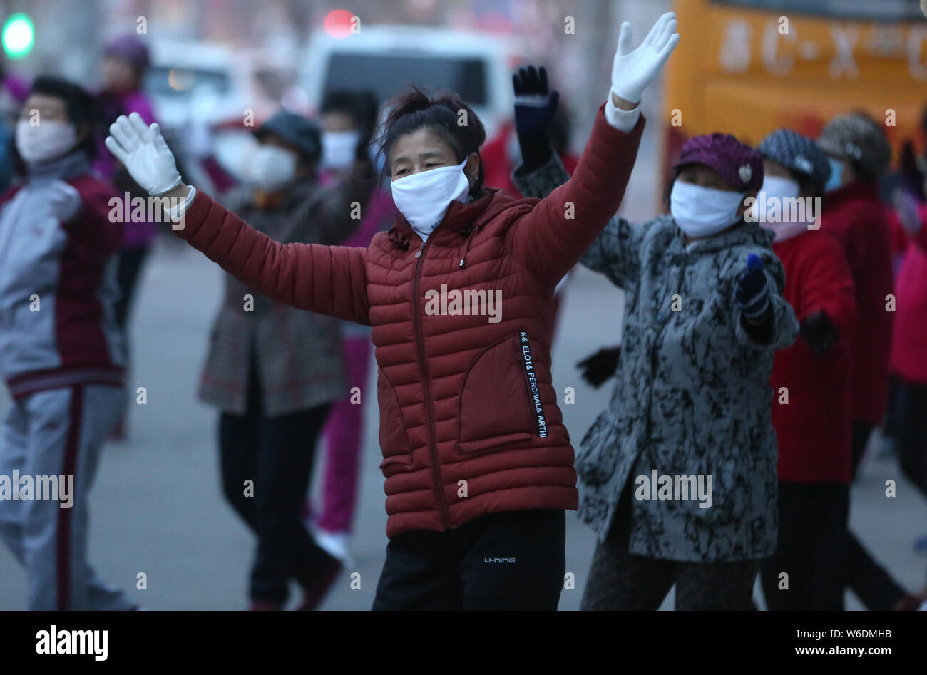 Local elderly women wearing face masks against air pollution do morning ...
