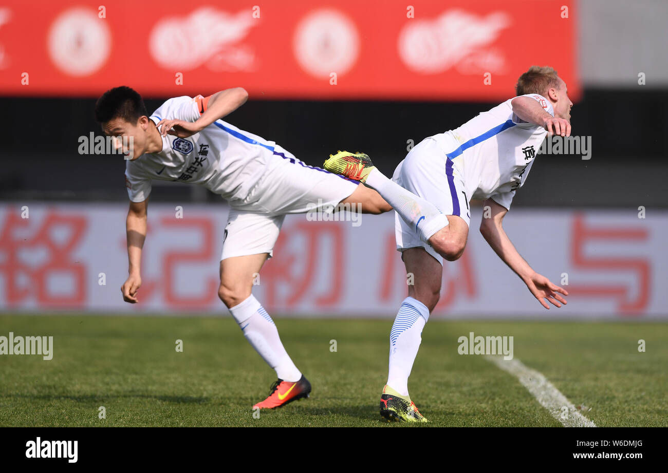 German football player Felix Bastians of Tianjin TEDA, right, kicks the ...