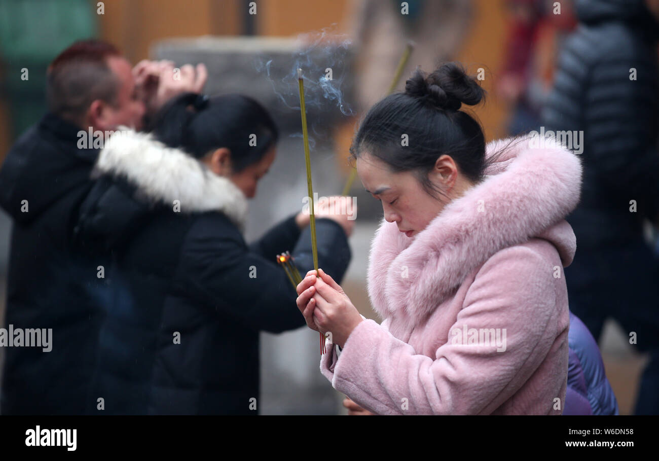 --FILE--A Chinese worshipper burns incense sticks to pray for good luck ...