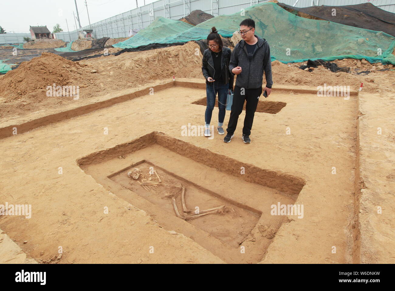Local residents look at a tomb between the Spring and Autumn Period ...
