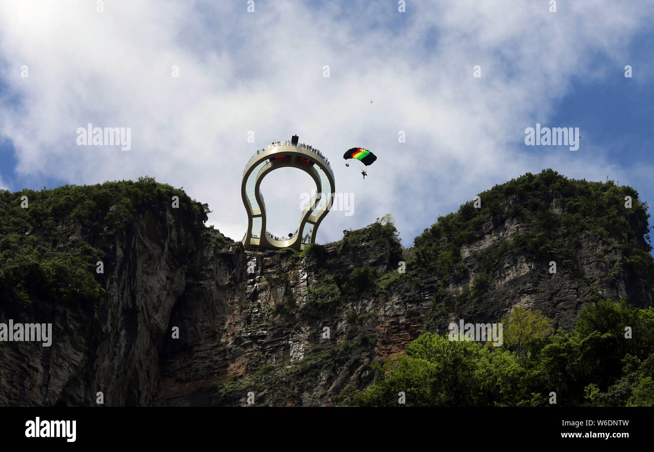 A contestant jumps off the glass cantilever bridge on the cliff during ...