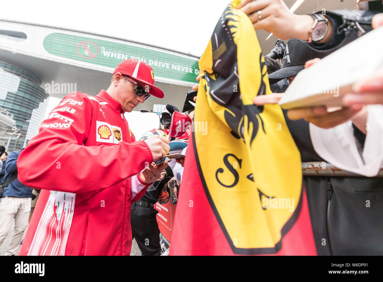 Finnish F1 driver Kimi Raikkonen of Ferrari signs autographs for fans ...