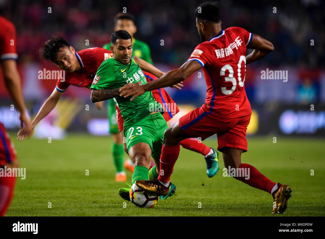 Spanish football player Jonathan Viera, center, of Beijing Sinobo Guoan ...