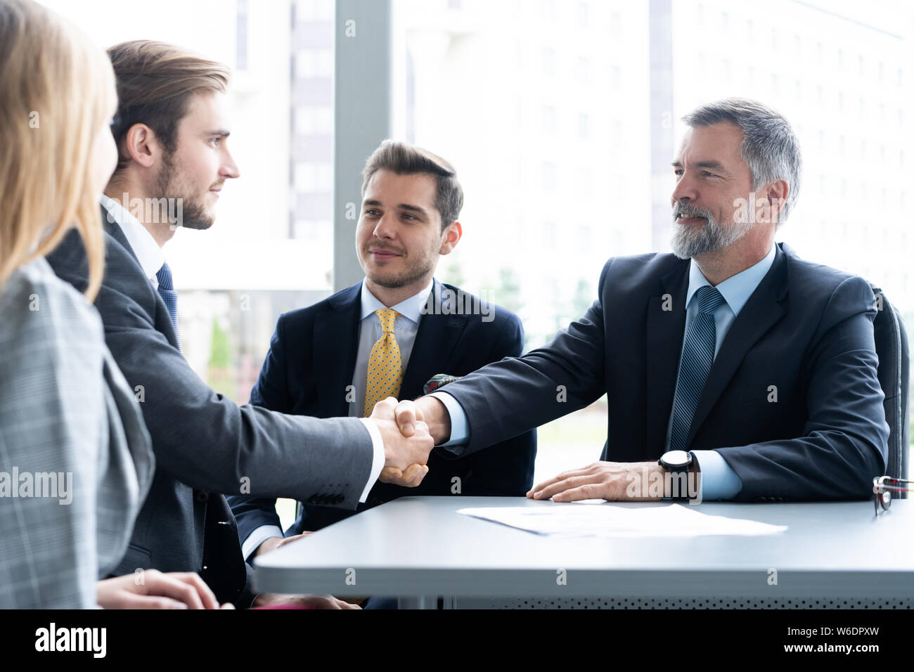 Business people shaking hands, finishing up a meeting. Handshake ...