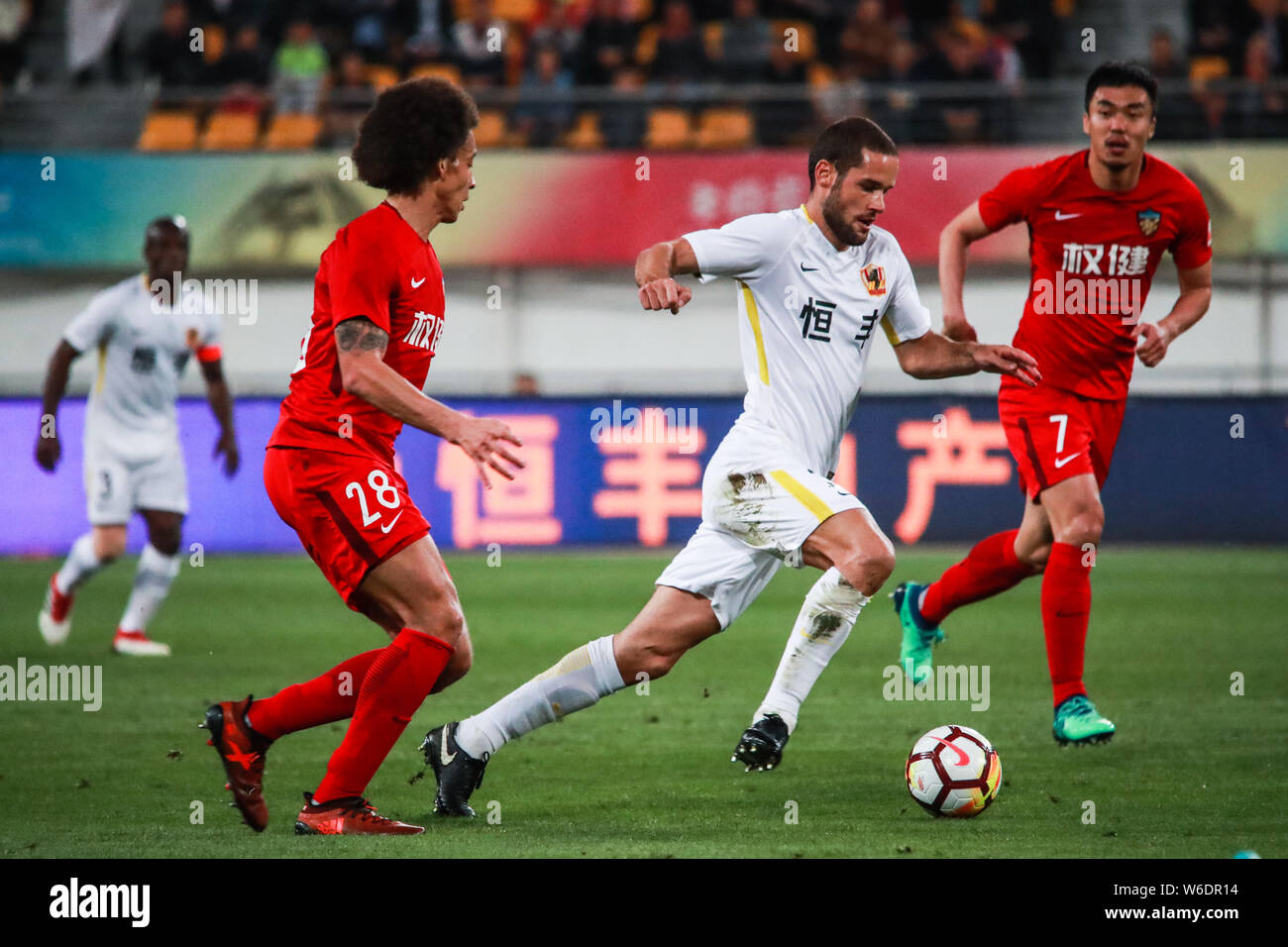Spanish soccer player Mario Suarez, right, of Guizhou Hengfeng kicks ...