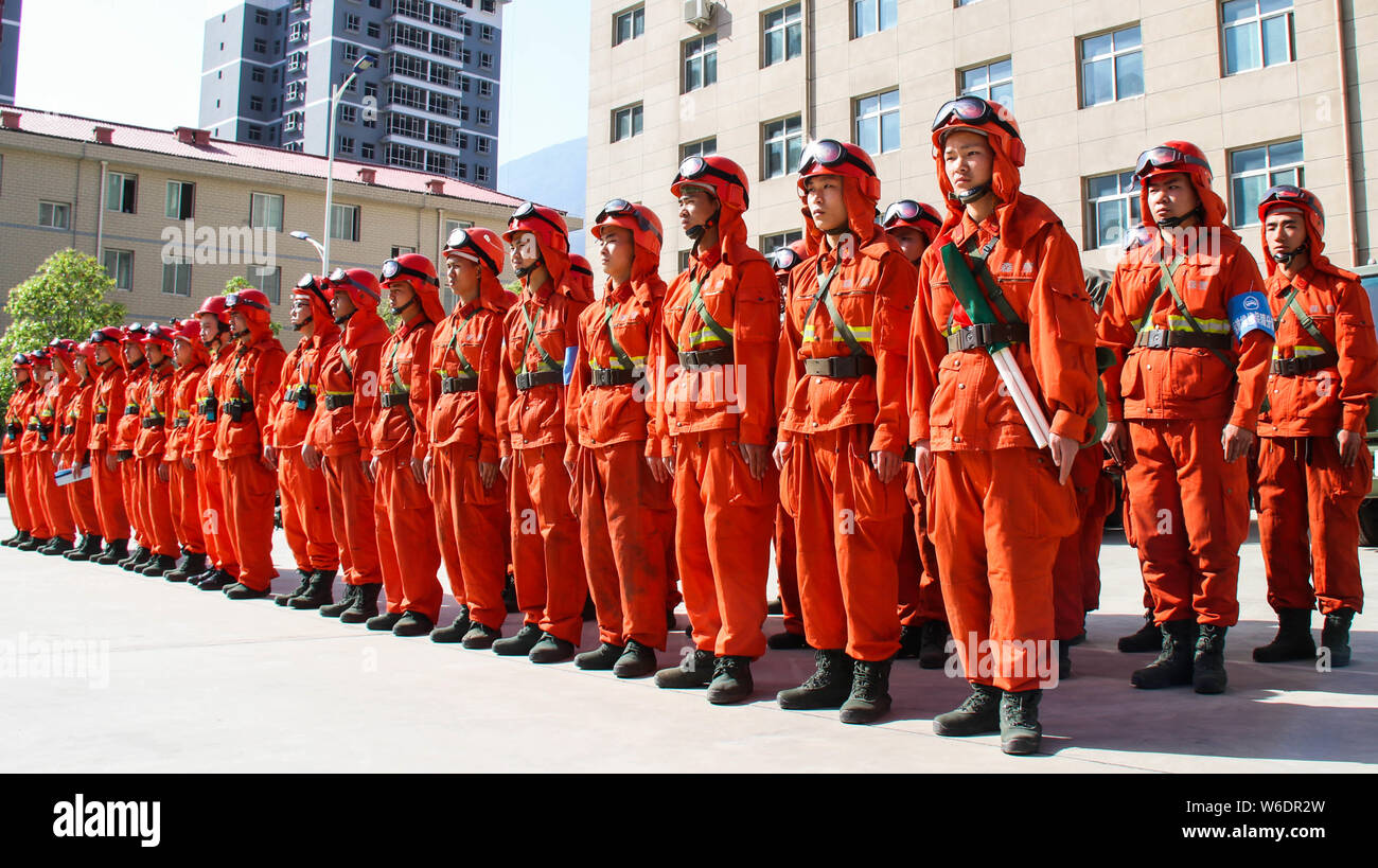 Chinese firefighters line up before taking part in a training session ...