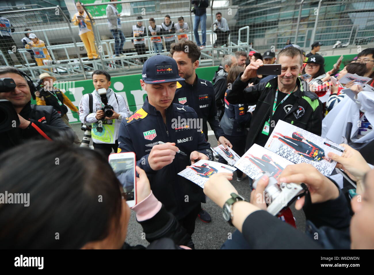 Dutch F1 driver Max Verstappen of Red Bull Racing autographs for fans ...