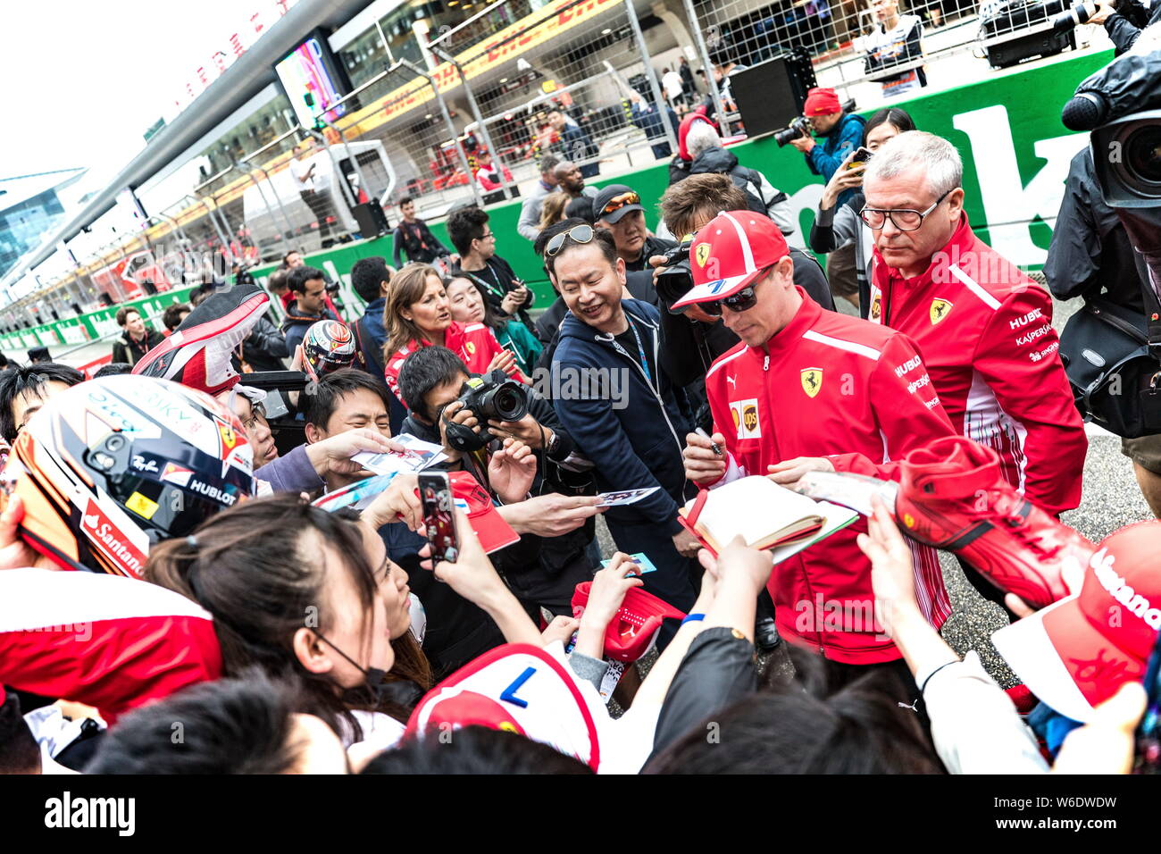 Finnish F1 driver Kimi Raikkonen of Ferrari signs autographs for fans ...