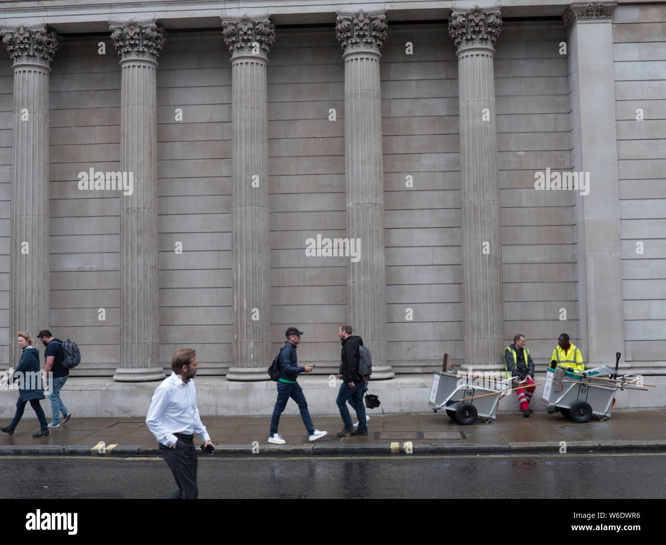 Street cleaners road sweepers taking a break outside the bank of ...