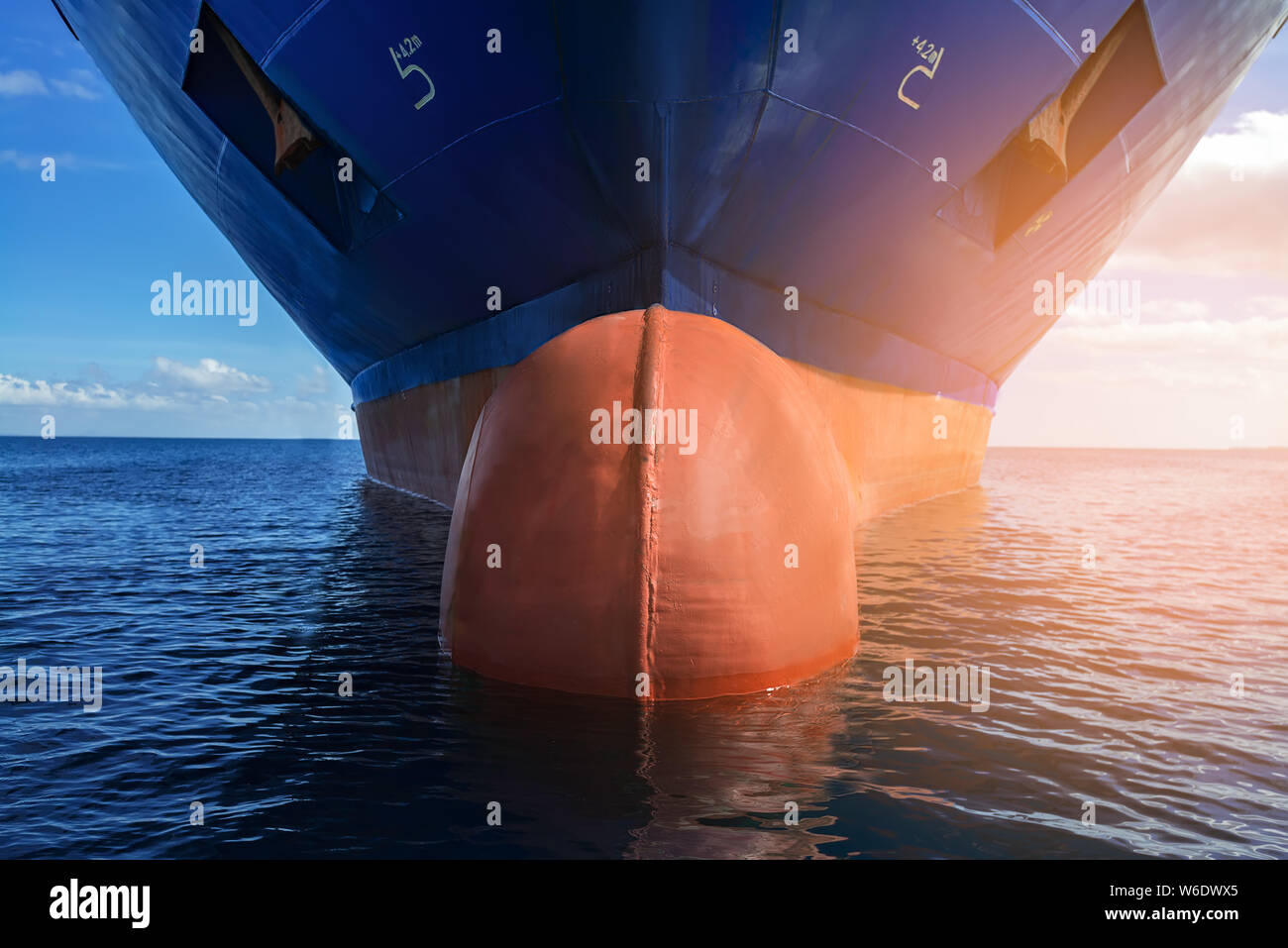 Close up of large blue merchant crago ship in the middle of the ocean ...