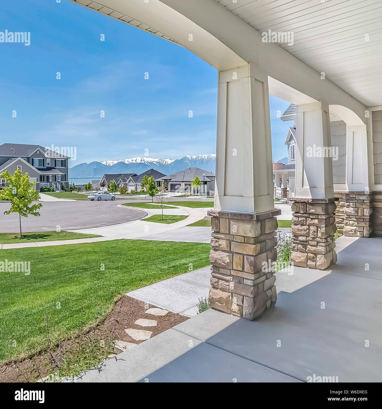 Square Porch with pillars and a combination of concrete and stone brick ...