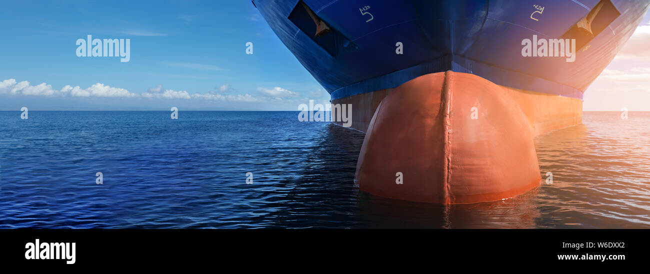 Close up of large blue merchant crago ship in the middle of the ocean ...